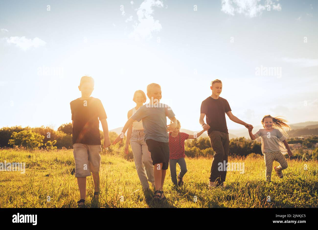Six kids brothers and sisters teenagers and little kids walking on the ...
