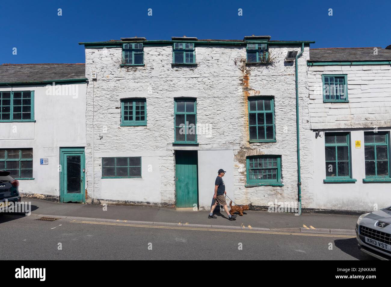 A colourful (lots of character) run down building. Broken windows ...