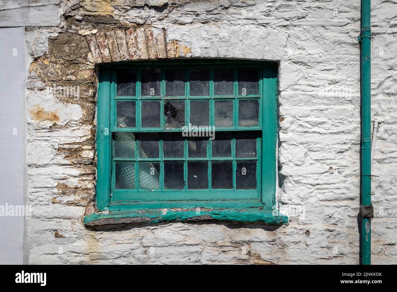 A colourful (lots of character) run down building. Broken windows ...