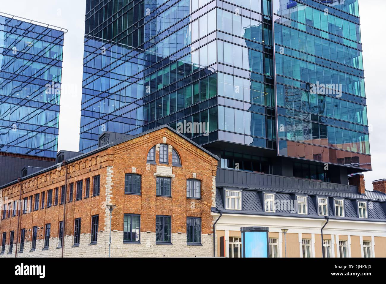 Glass and steel skyscrapers next to old brick buildings in the center ...