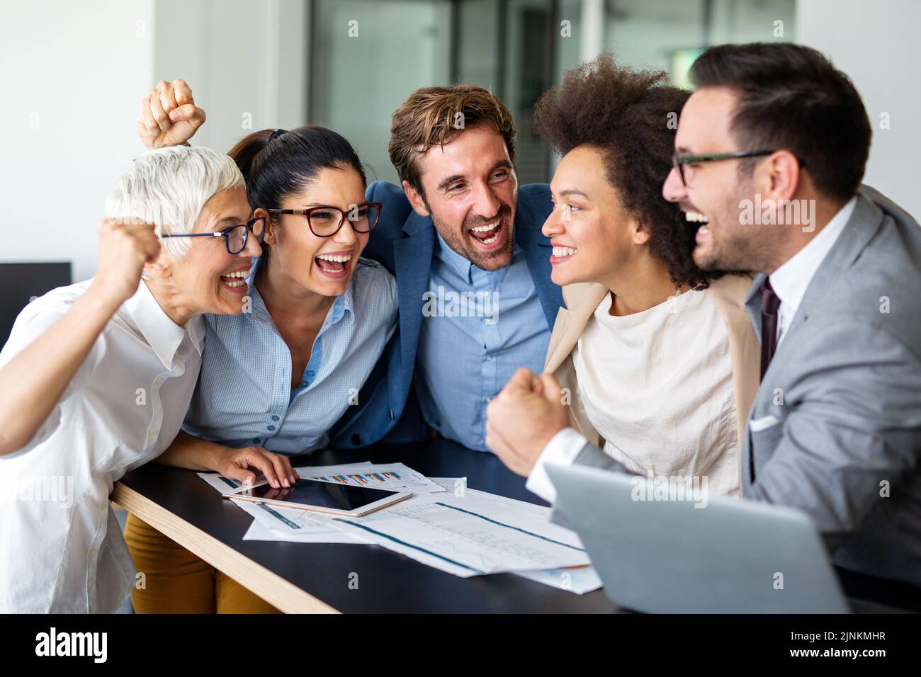 Team celebrating colleague success hi-res stock photography and images ...