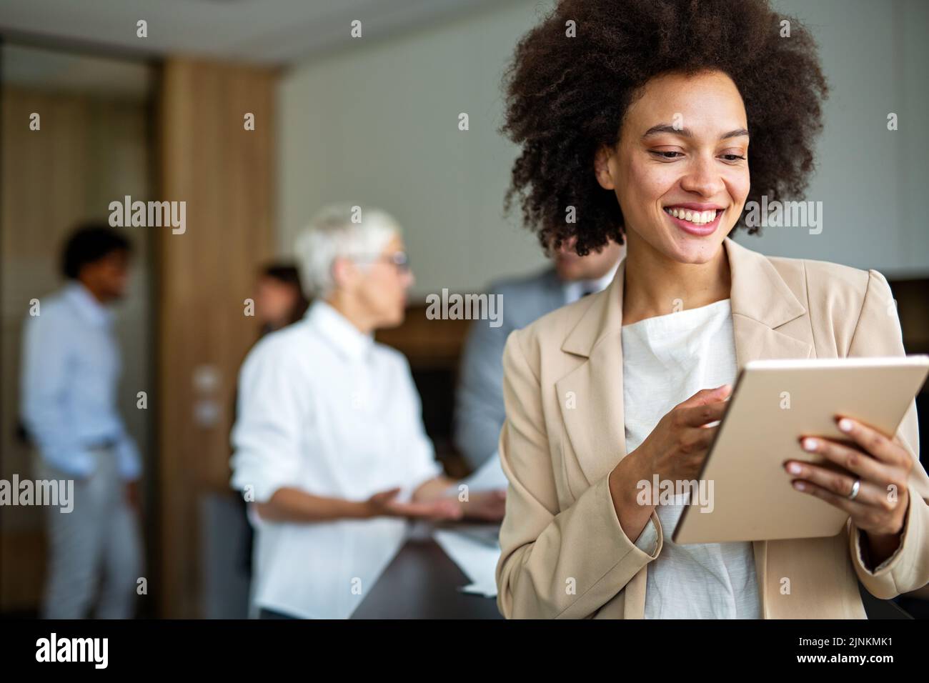 Happy business woman manager holding tablet and working in modern ...