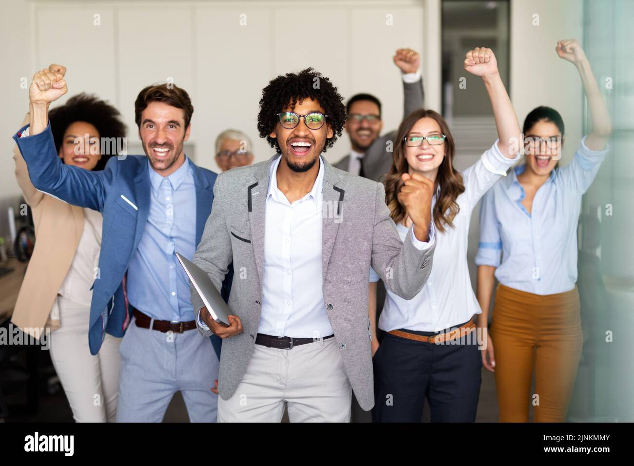 Group of successful multiethnic business people celebrating a good job ...