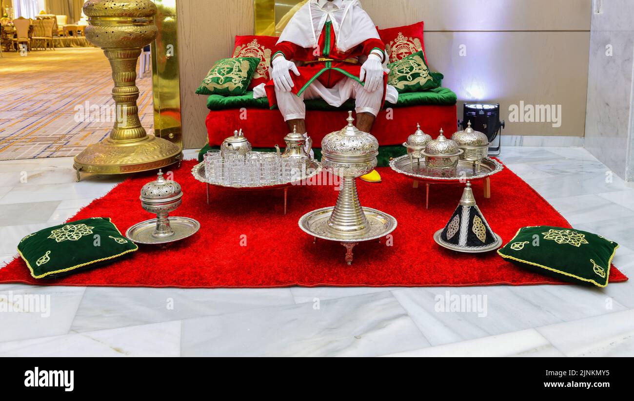 Moroccan wedding reception. Moroccan man pours tea for guests Stock ...