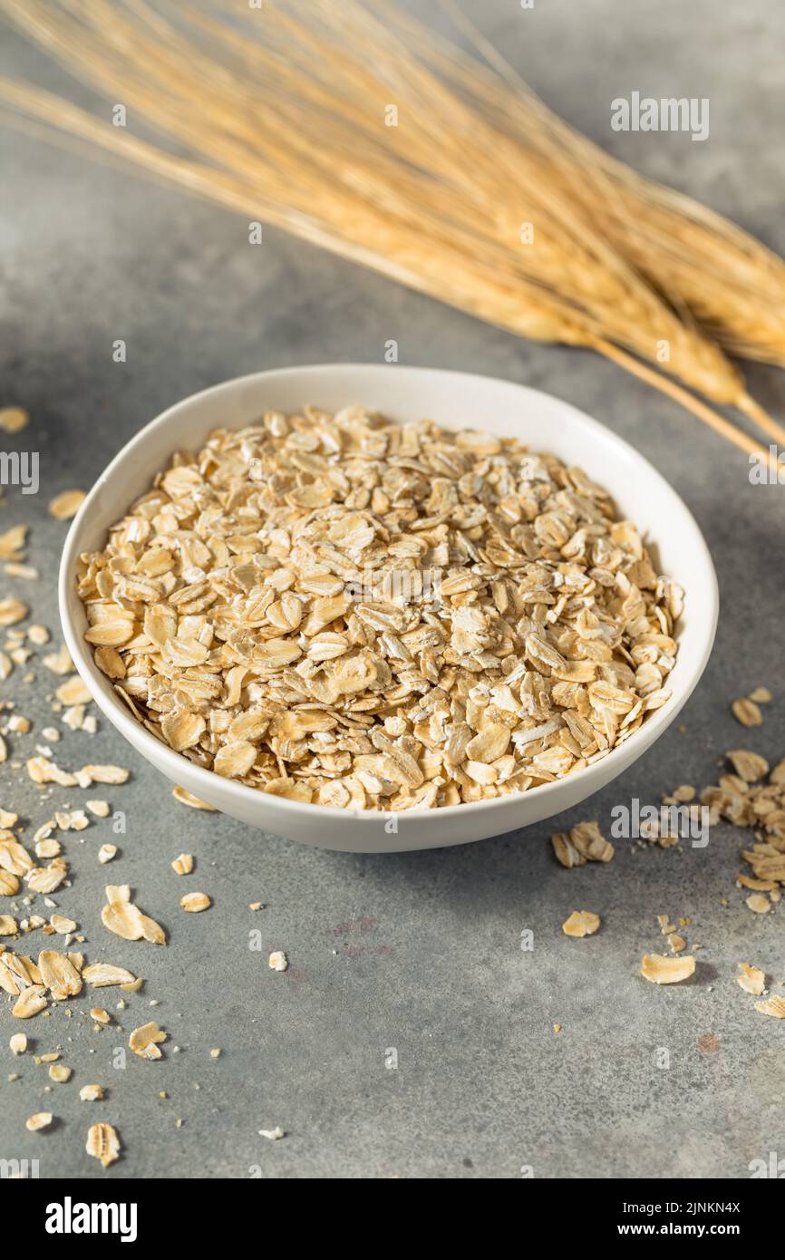 Dry Organic Rolled Oats Oatmeal in a Bowl Stock Photo - Alamy