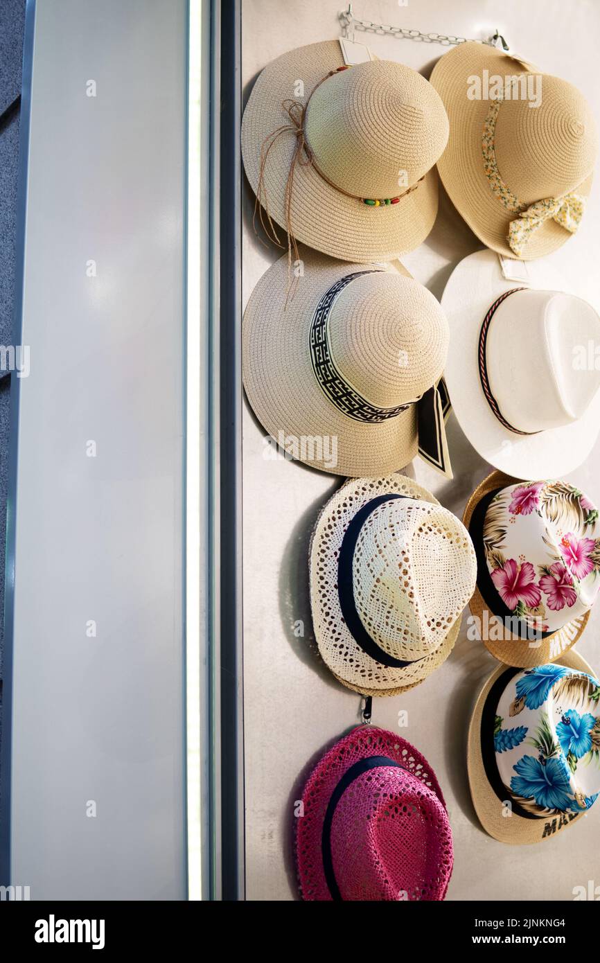 beach hats in store window Stock Photo - Alamy