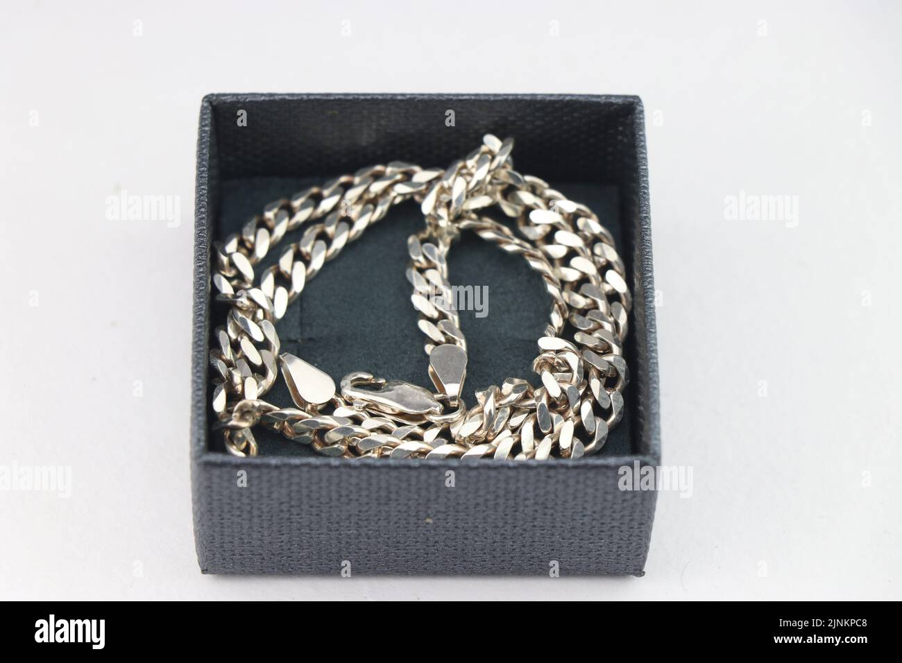 Silver chain or necklace with beautiful chain links kept in a box for ...