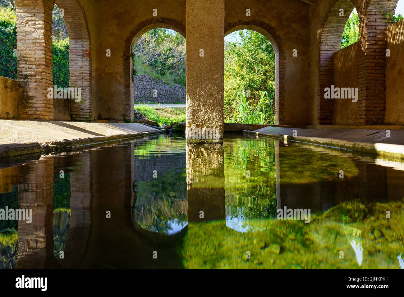 Small house with arches and fountain making reflections in the water ...