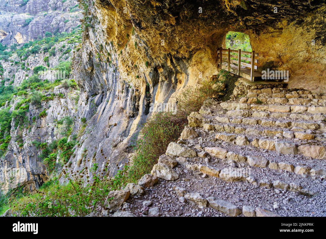 Cave in the mountain with a path with steps for hikers Stock Photo - Alamy