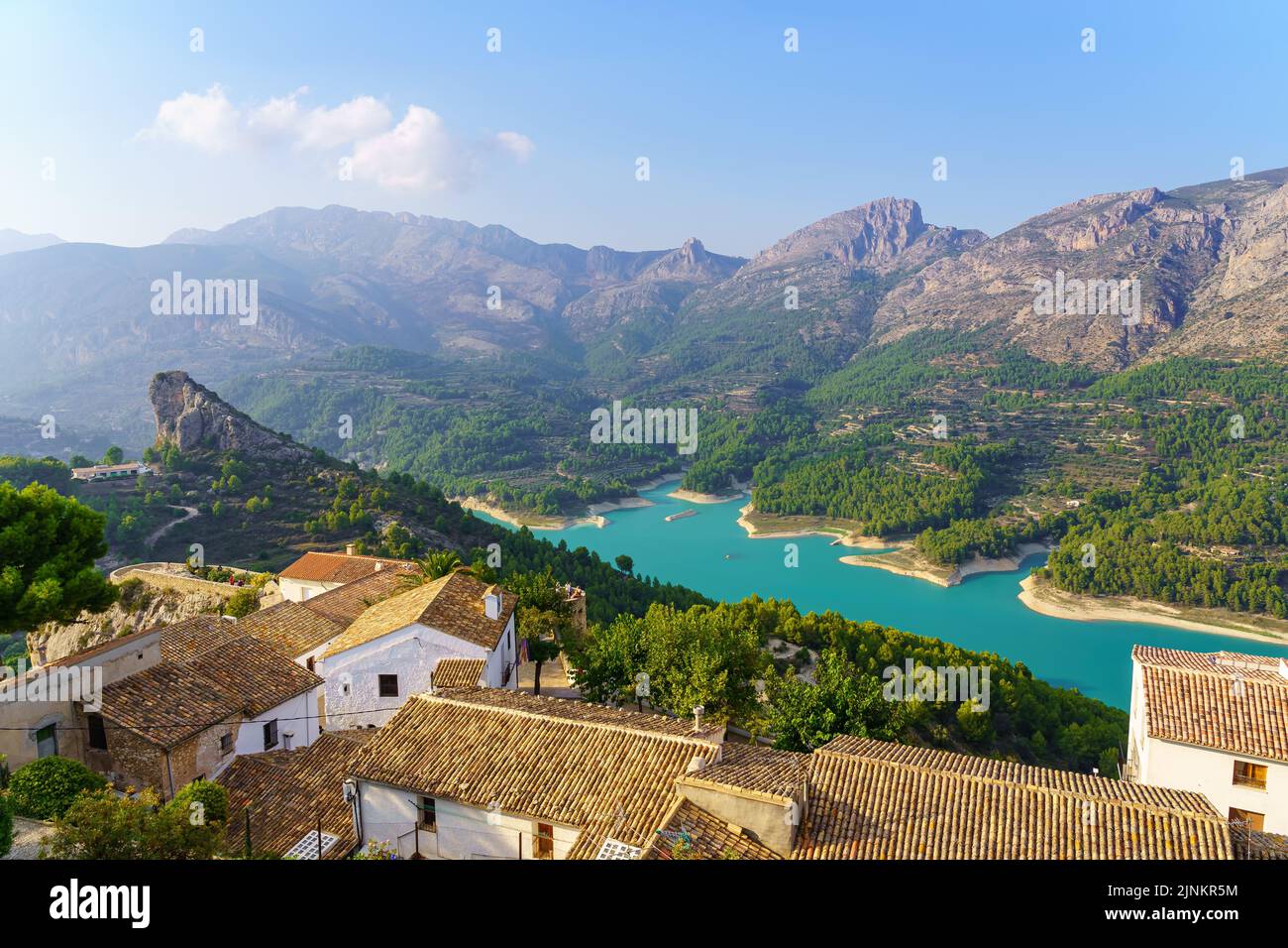 Blue lake in the valley and houses in mountains in southern Spain ...