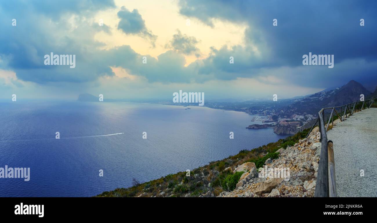 Aerial view of the beach bay with a small boat approaching the port ...