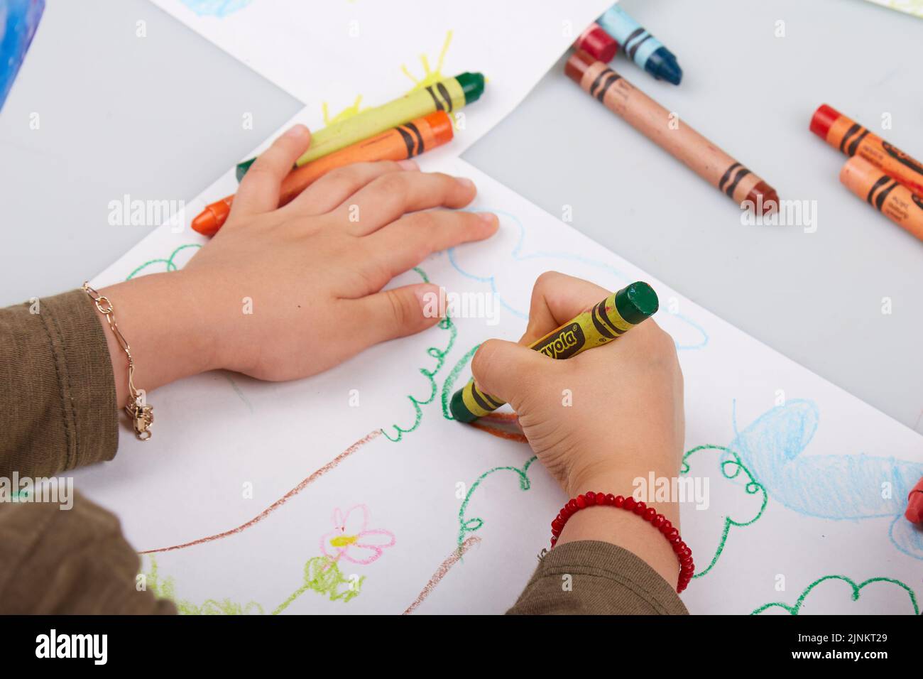 Toddler drawing with crayons Stock Photo - Alamy