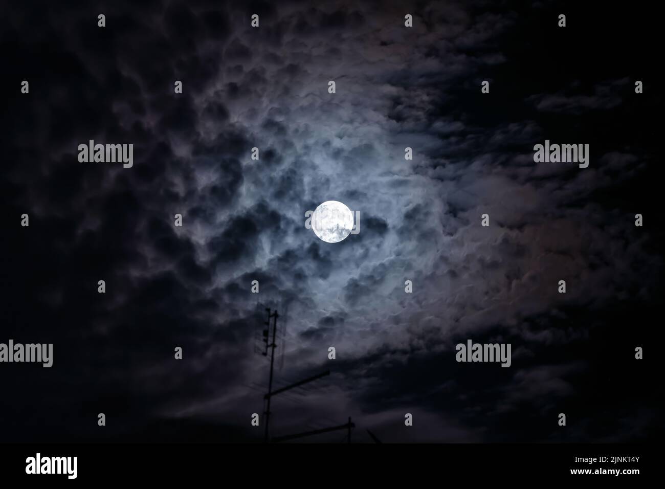 Full moon at night. The illuminated face of the moon is wrapped in a ...