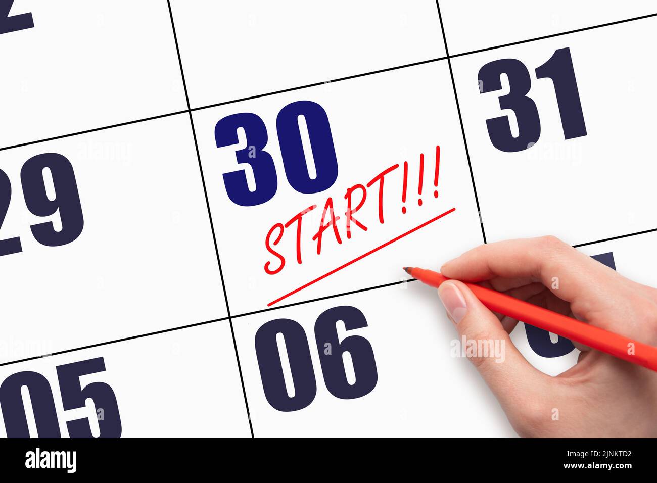 30th day of the month. Hand writing text START and drawing a line on ...