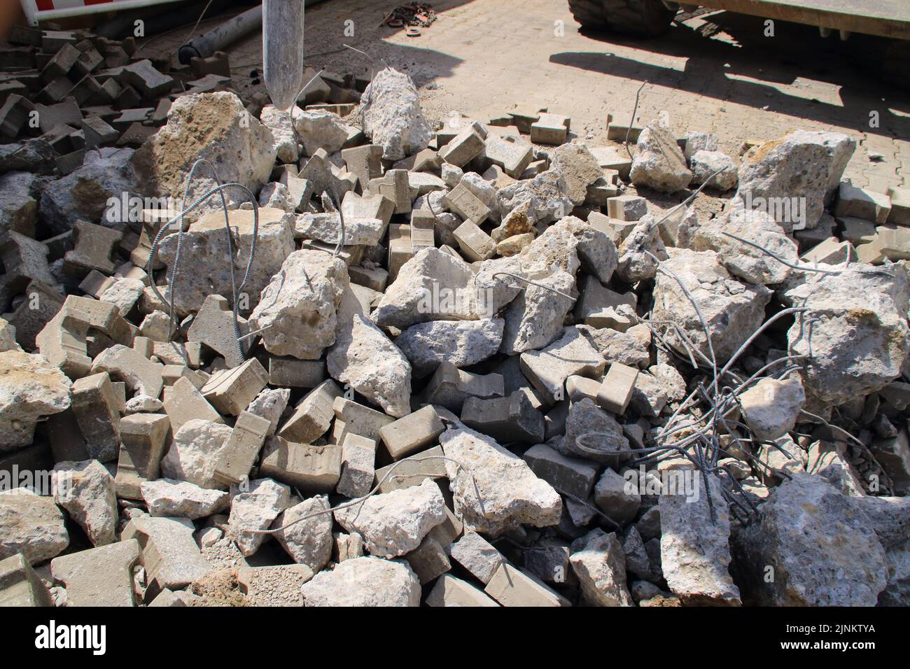 Concrete residues from building rubble were crushed with a chisel Stock ...