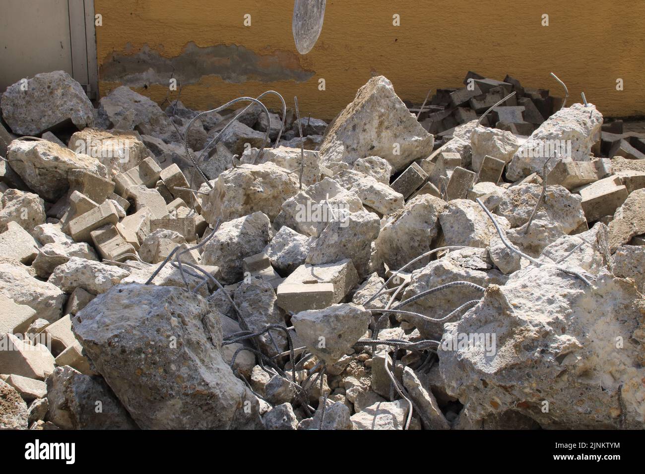 Concrete residues from building rubble were crushed with a chisel Stock ...