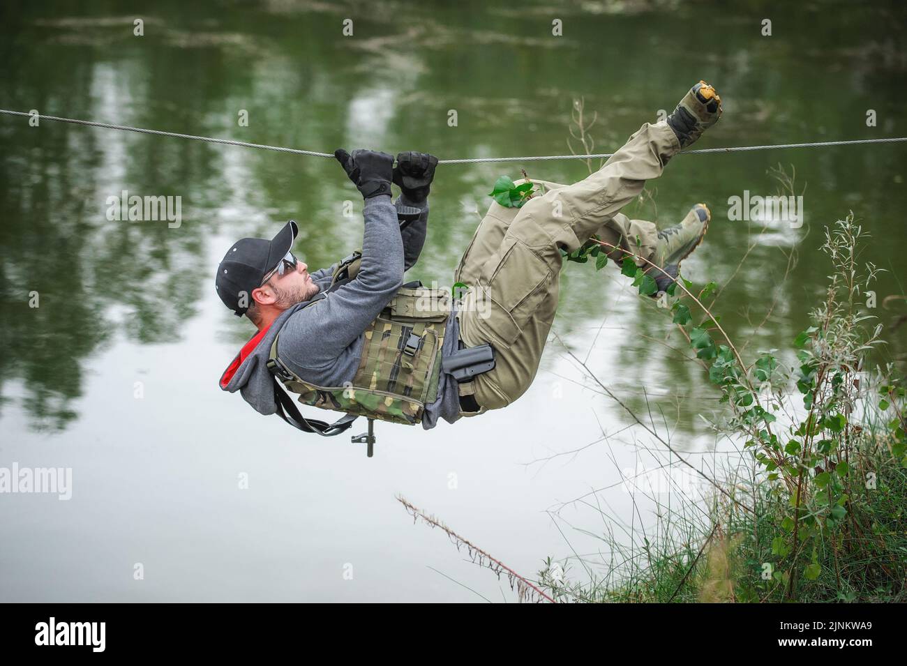 Army soldier shooting with rifle machine gun in the forest. Nature ...