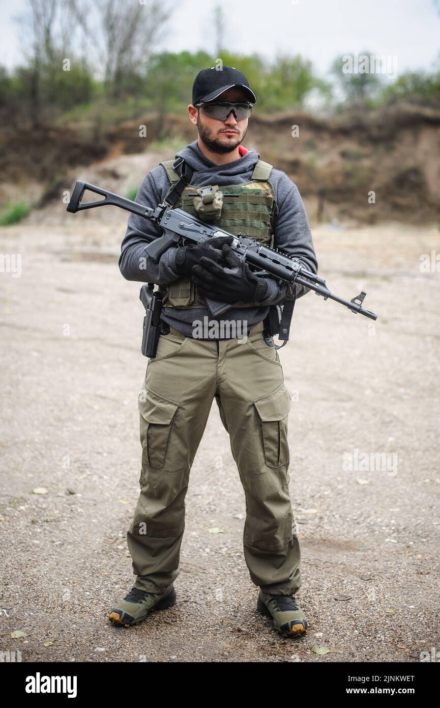 Army soldier shooting with rifle machine gun in the forest. Nature ...