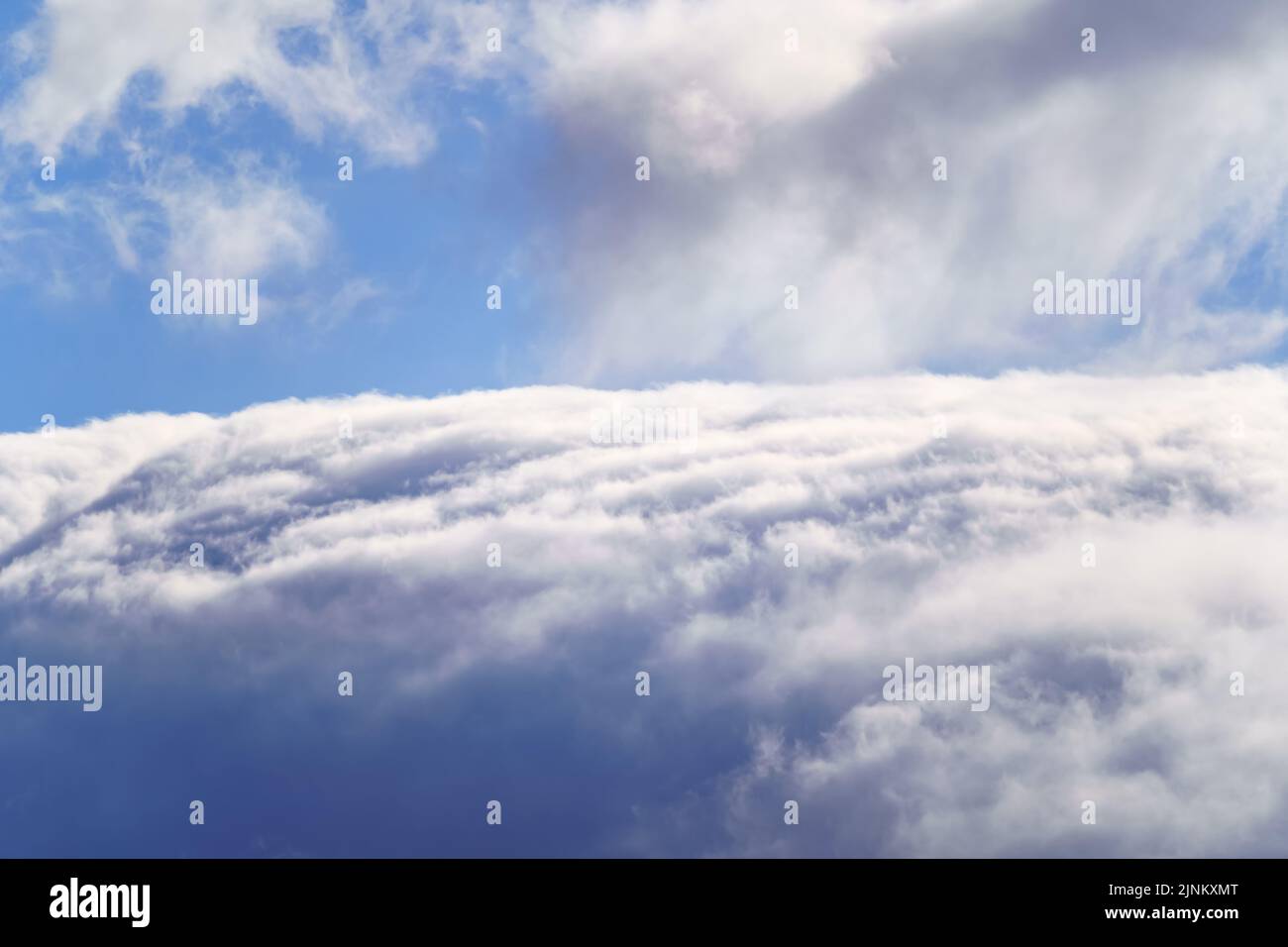 Background of high clouds covering the mountain and blue sky above the ...
