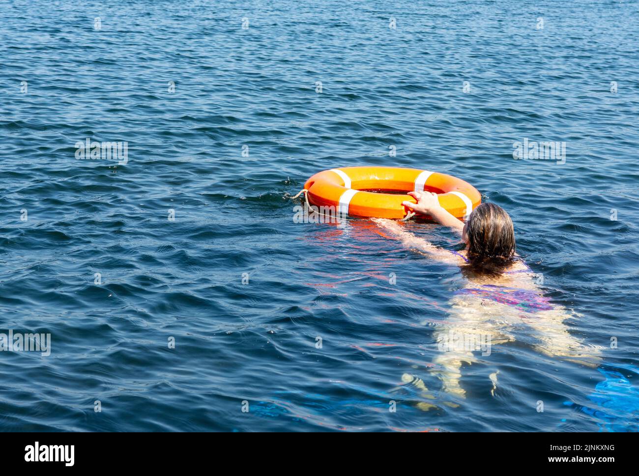 A person in the water gets a lifeline to help. The concept of saving ...