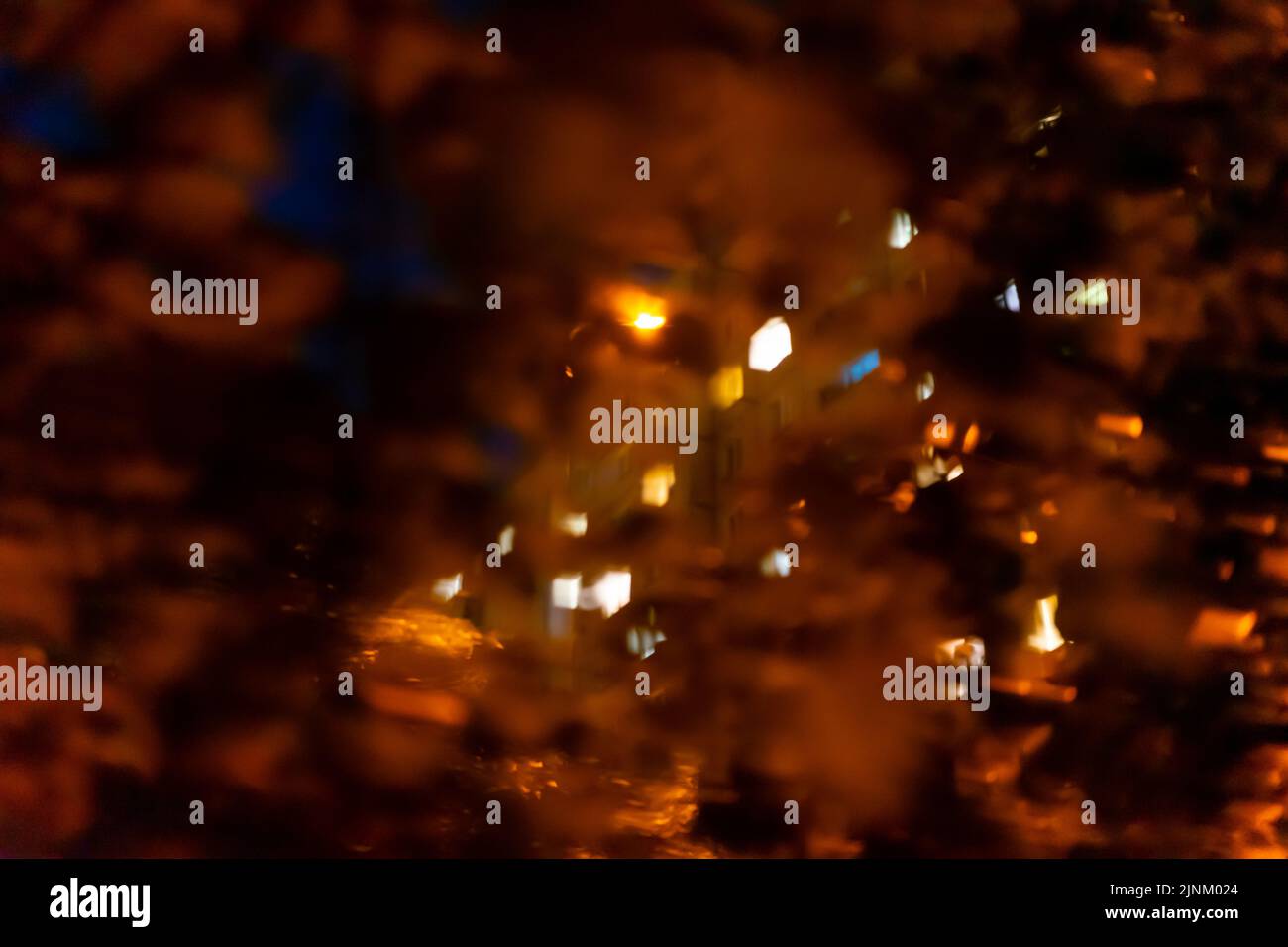 Light in the windows of the house at night. Abstract scary landscape ...