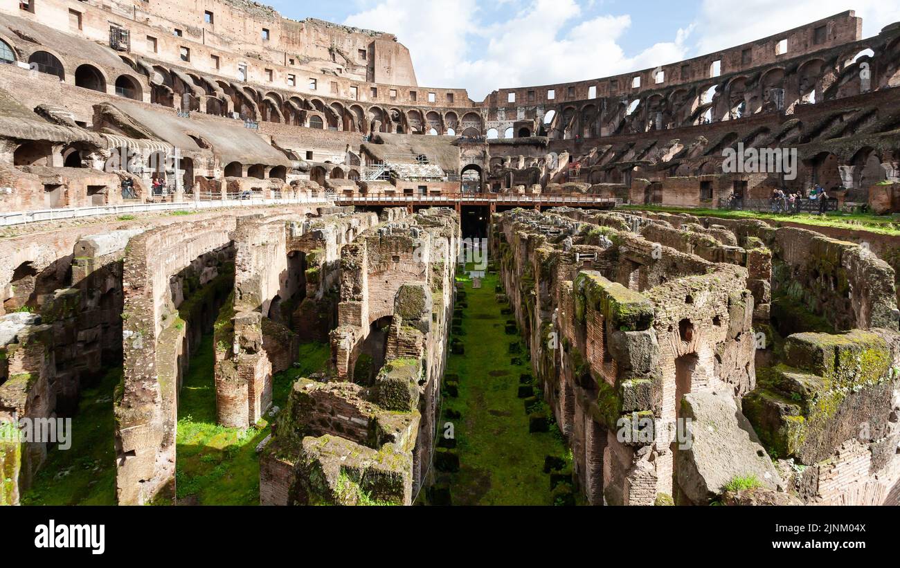 Tourists walking among the ruins of the Roman Colosseum, Rome, Italy ...