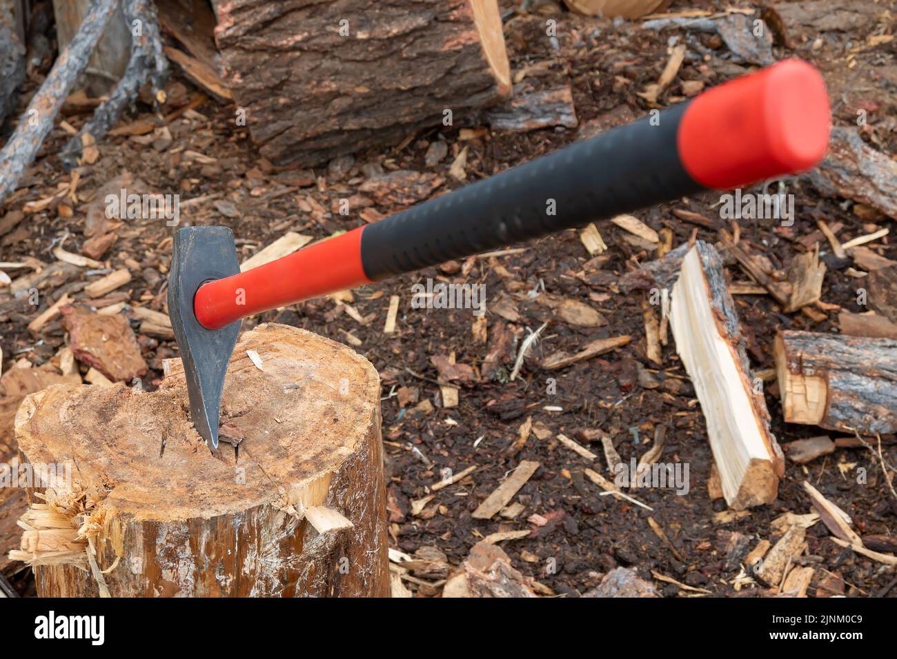 a view of a large cleaver, an axe with a plastic, rubber handle, which ...