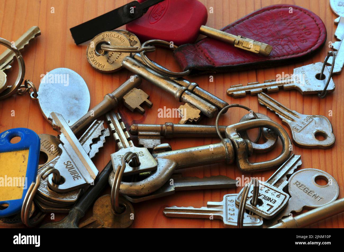 Assortment of various keys and fobs on table Stock Photo - Alamy