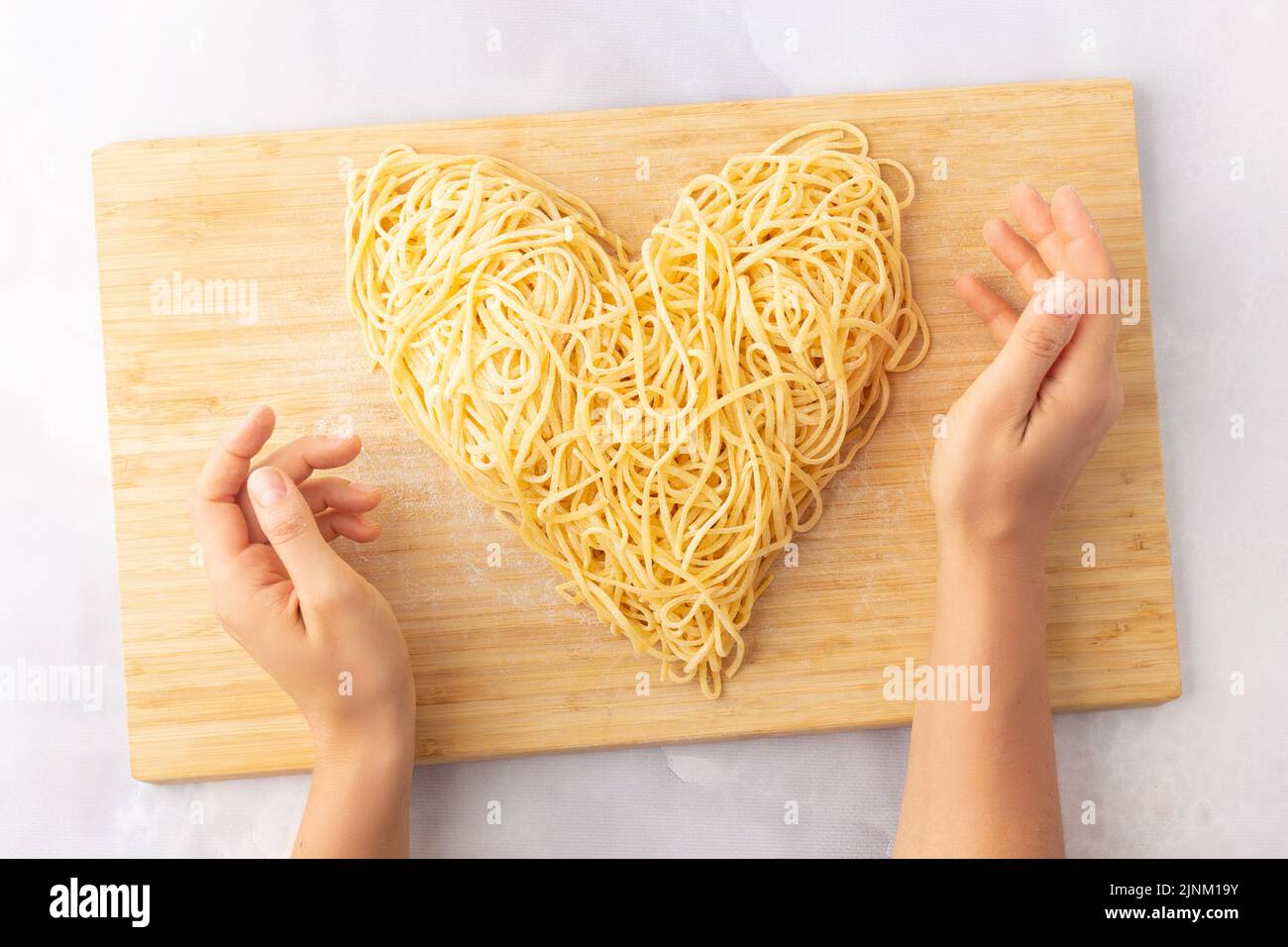Decorative heart shaped pasta still life formed of pasta topped with ...