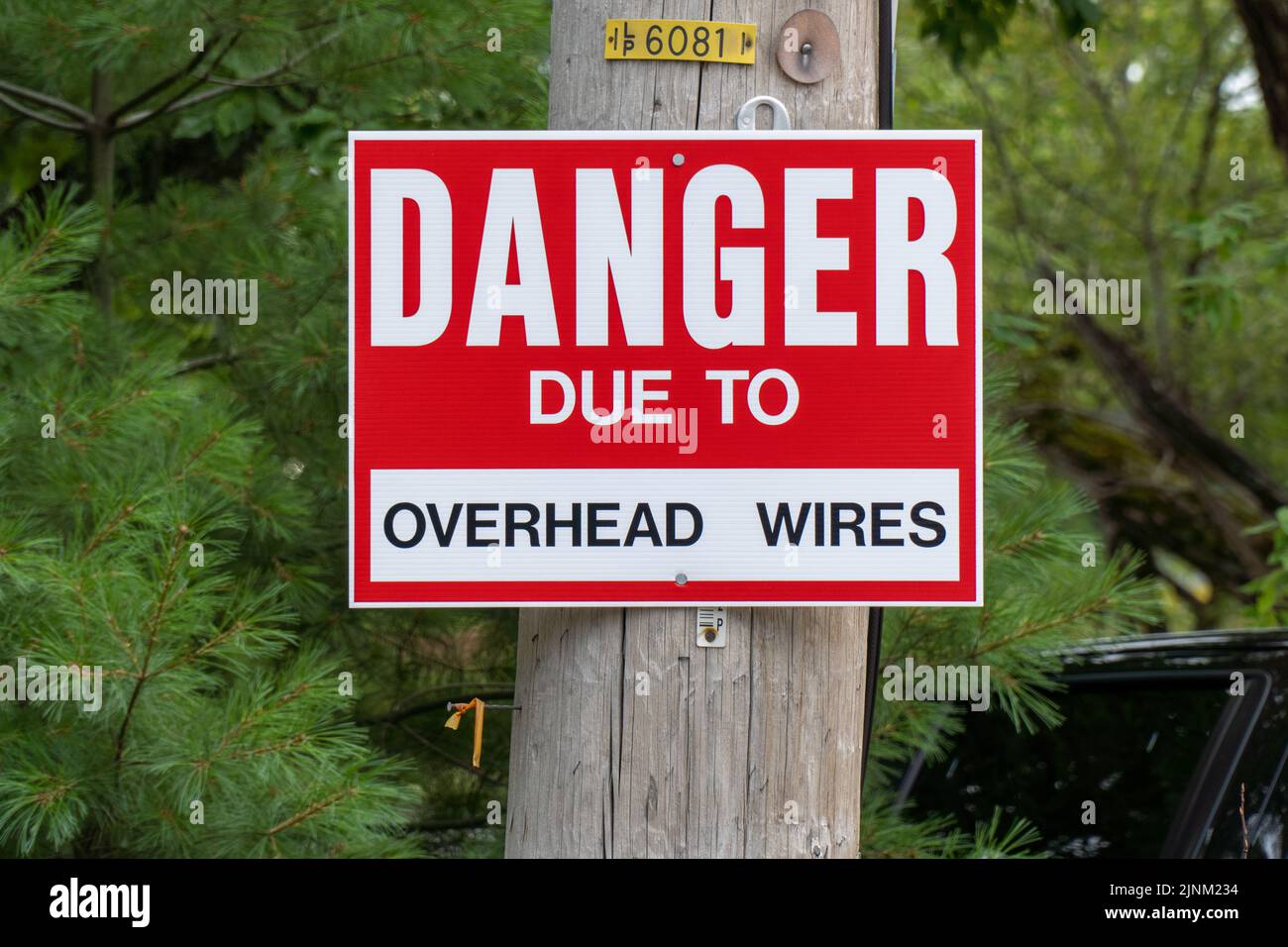 Danger due to overhead wires sign Stock Photo - Alamy