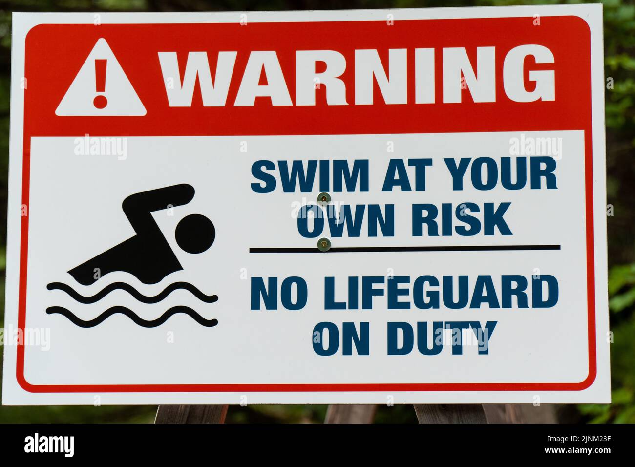 Swim at your own risk no lifeguard on duty Stock Photo - Alamy