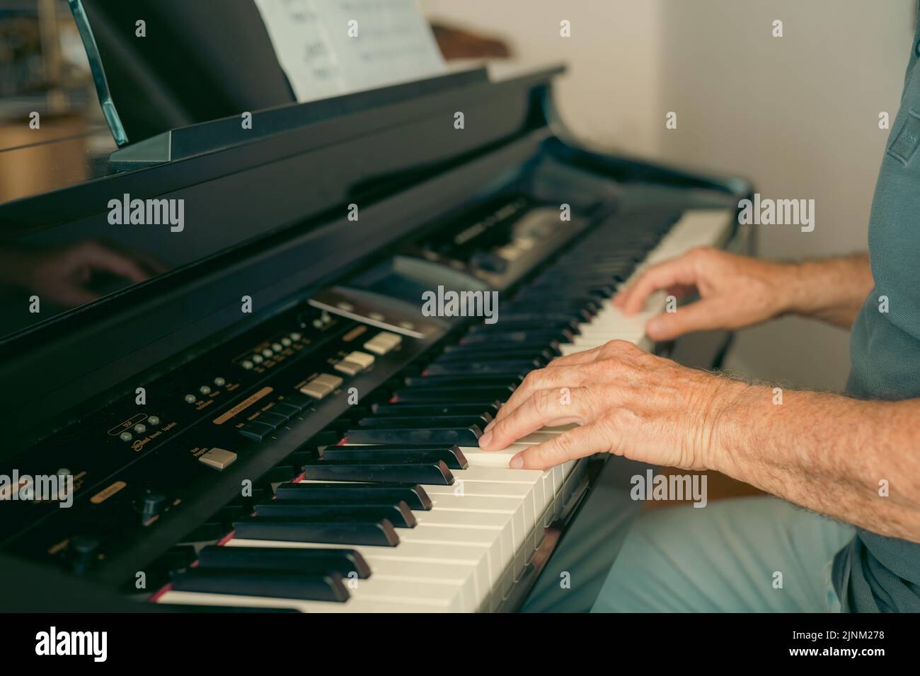 Old person's hands playing the piano. Close up view of skin texture and ...