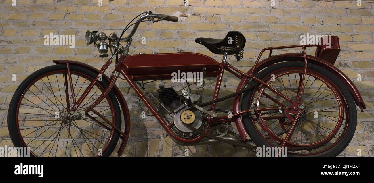 Red bike with a white brick background Stock Photo - Alamy