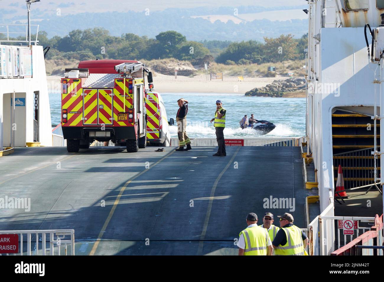 A fire engine on a chain ferry heading to the scene of a fire on ...