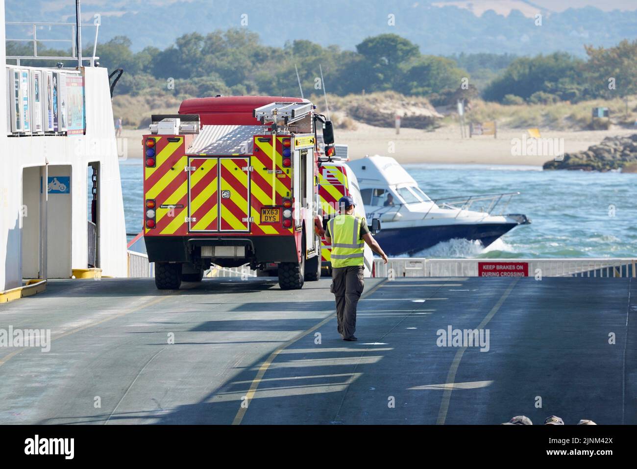 A fire engine on a chain ferry heading to the scene of a fire on ...