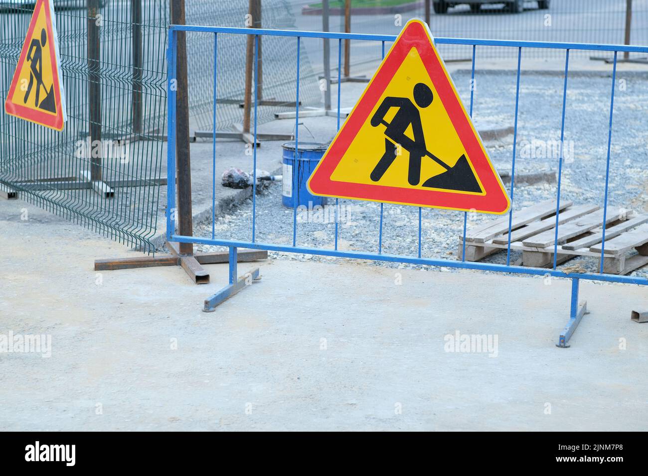 Warning sign on metal fence. Road sign with red and yellow marking ...
