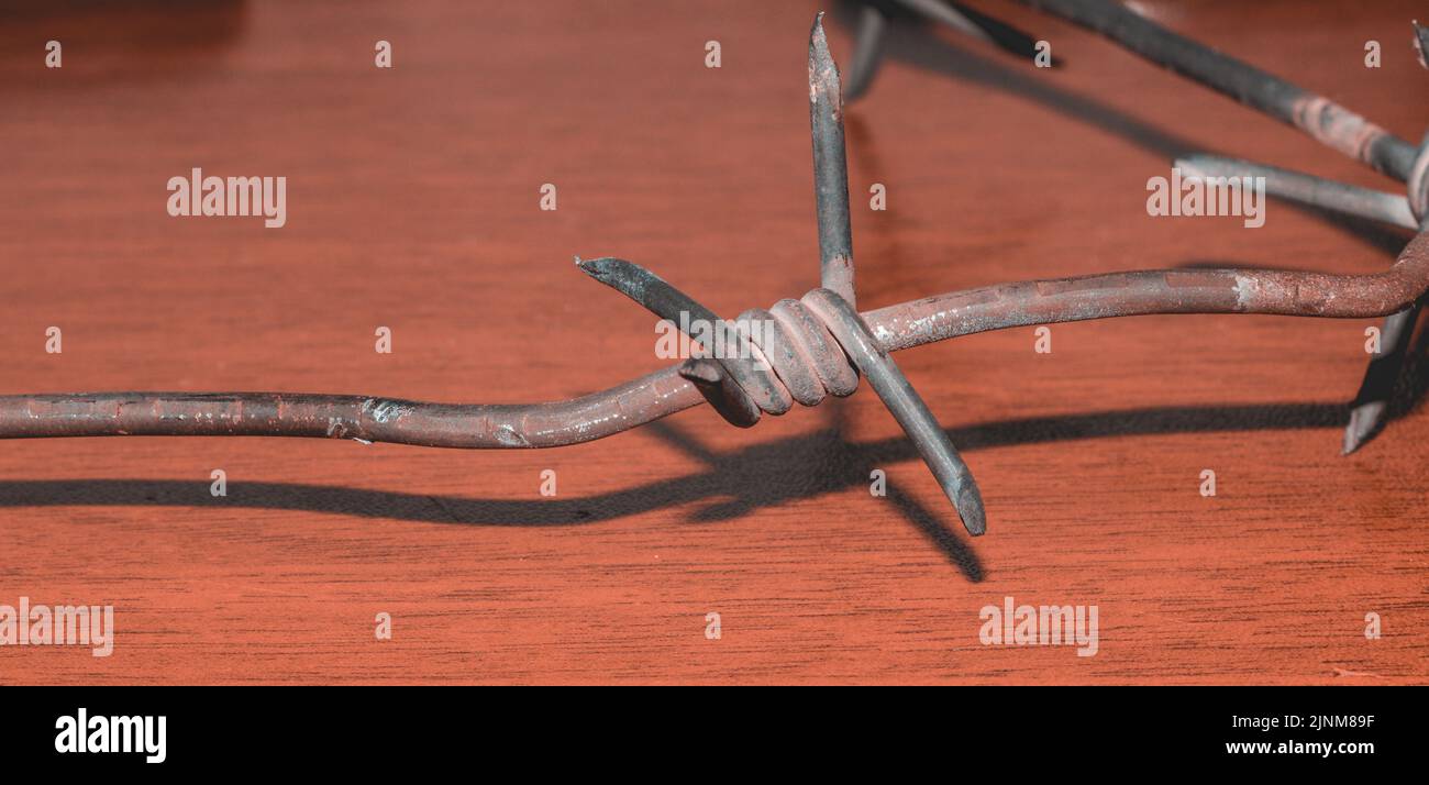Barbed Wire on table, concept sanctions Stock Photo - Alamy