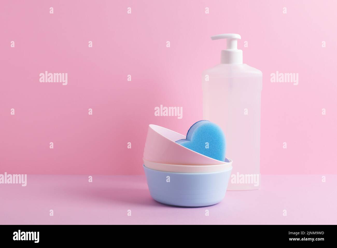 Decorative kitchen composition with clean plates, sponge and dish wash ...