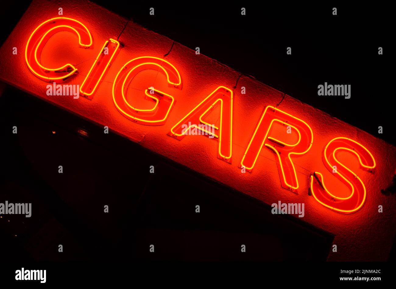 A dutch angle shot of a neon light "CIGARS" signage Stock Photo - Alamy