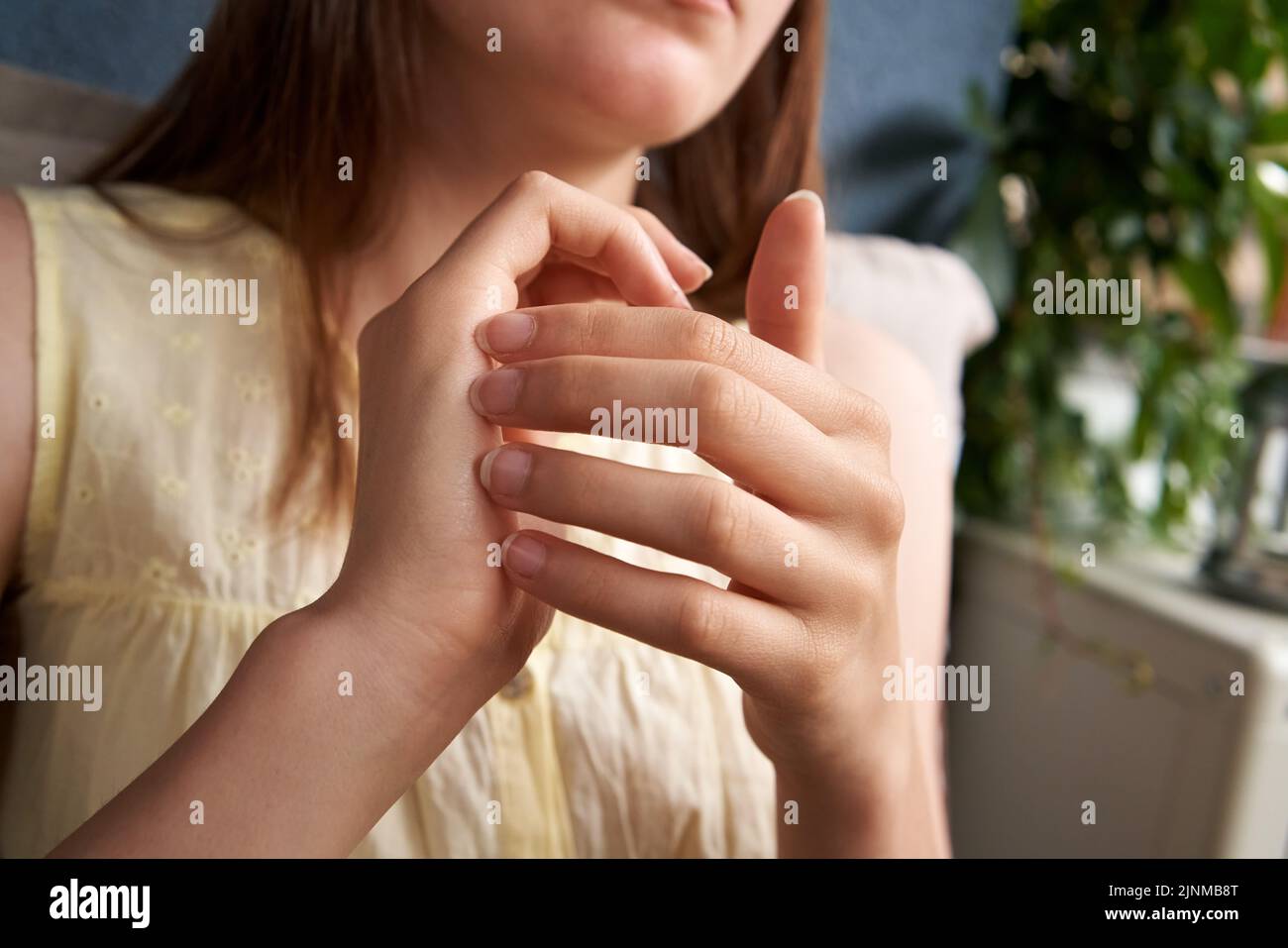 Young girl practicing EFT or emotional freedom technique - tapping on ...