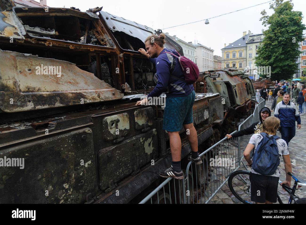 Lviv, Ukraine. 12th Aug, 2022. People look at the displayed Russian ...
