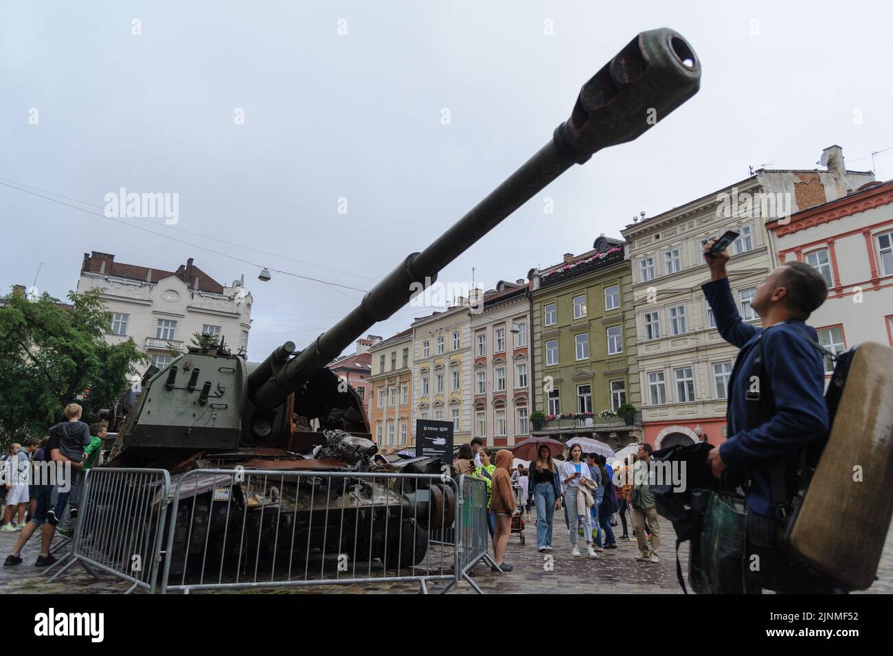 Lviv, Ukraine. 12th Aug, 2022. People look at the displayed Russian ...