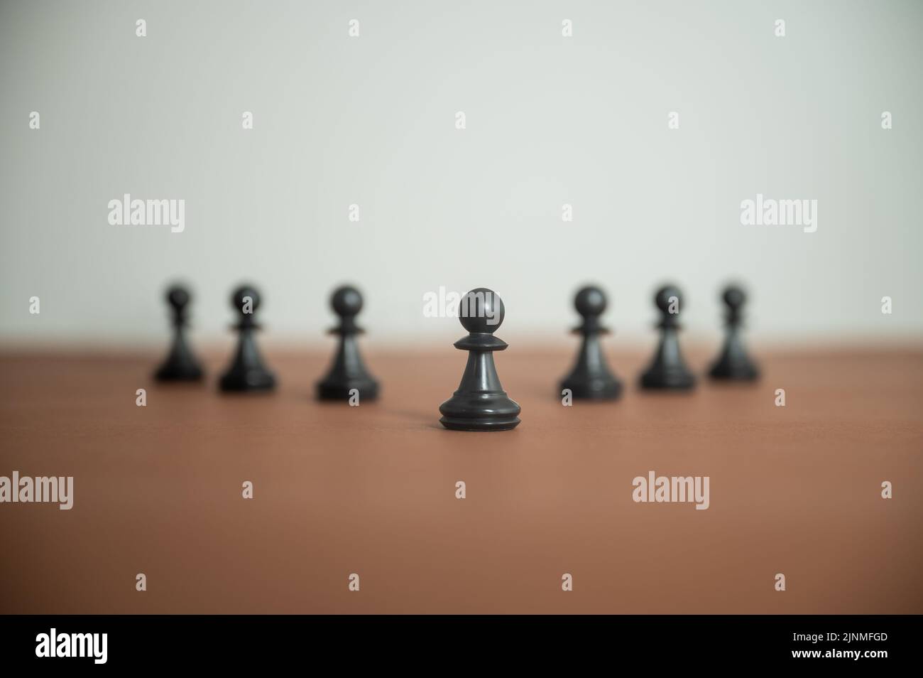 Low angle view of chess pawn figures placed in a pyramid shaped line on ...