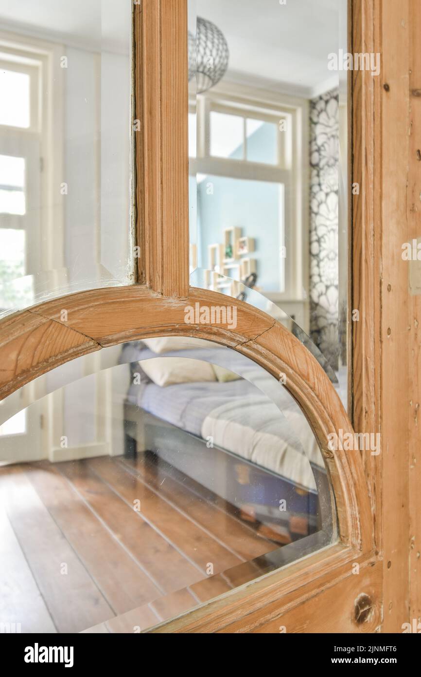 Home interior design of bedroom with bed and wooden wardrobe placed in ...