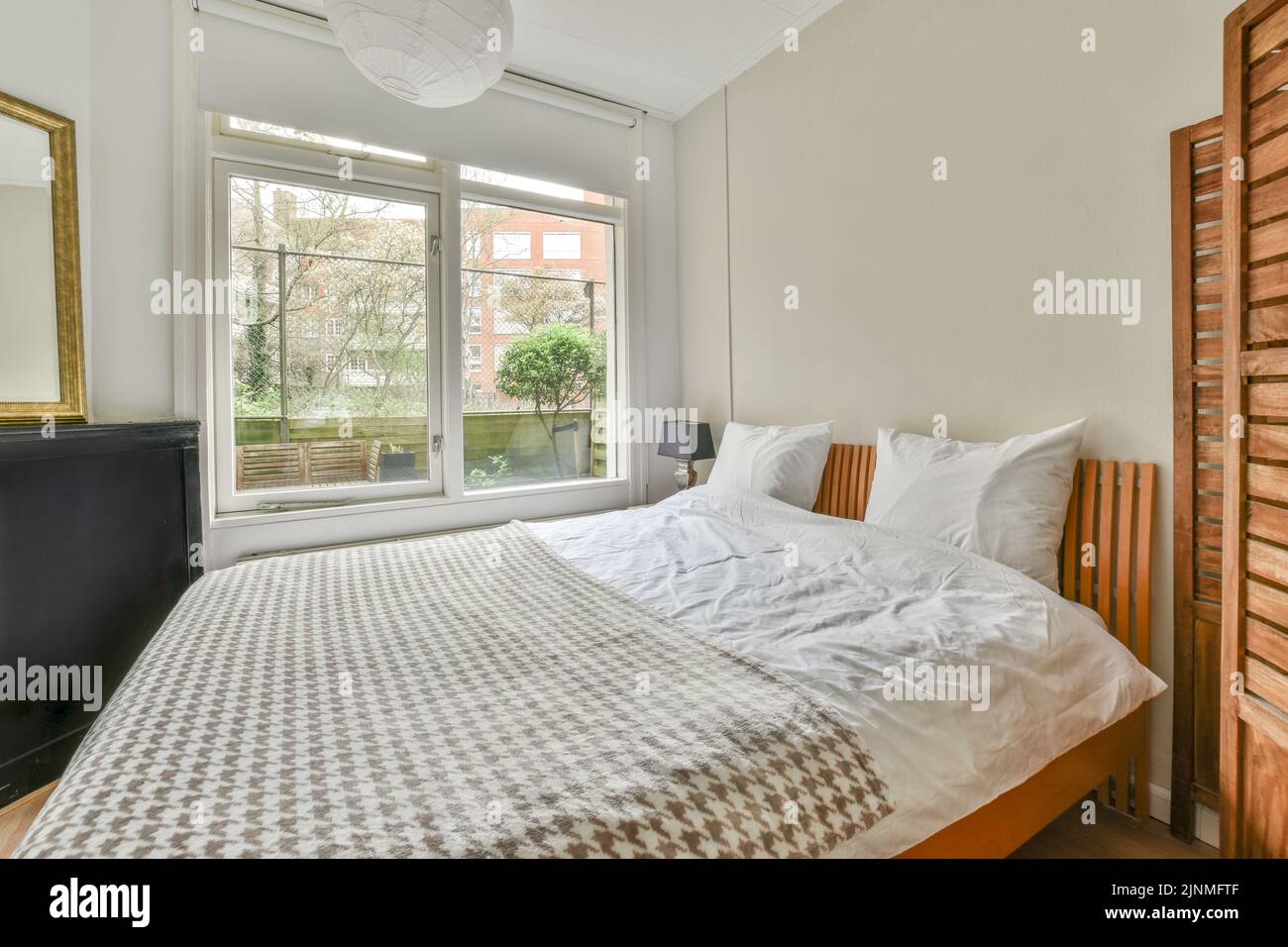 Comfortable bed and dining table in spacious bedroom with interior in ...