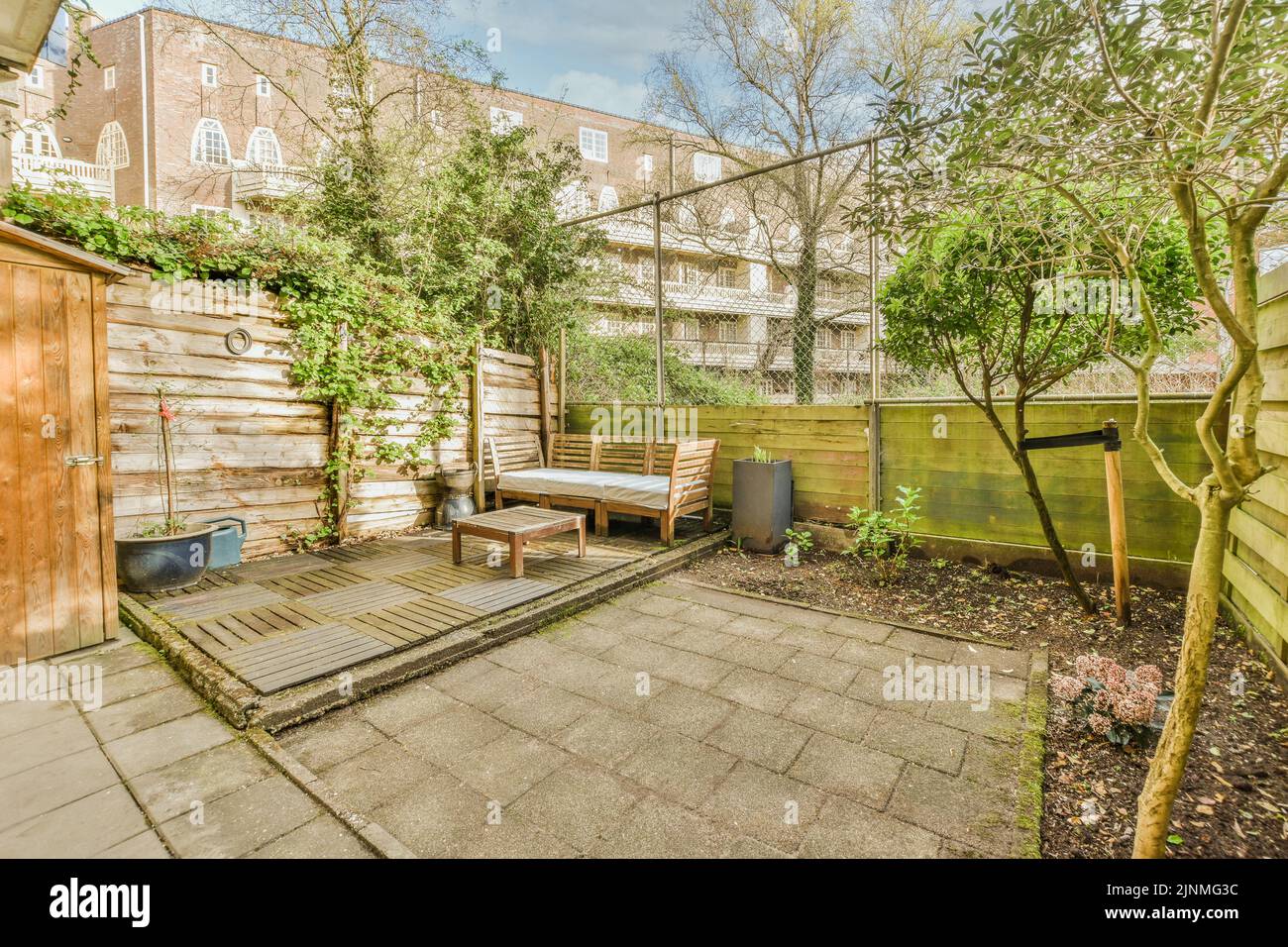 Simple small empty patio with snear wooden fence Stock Photo - Alamy