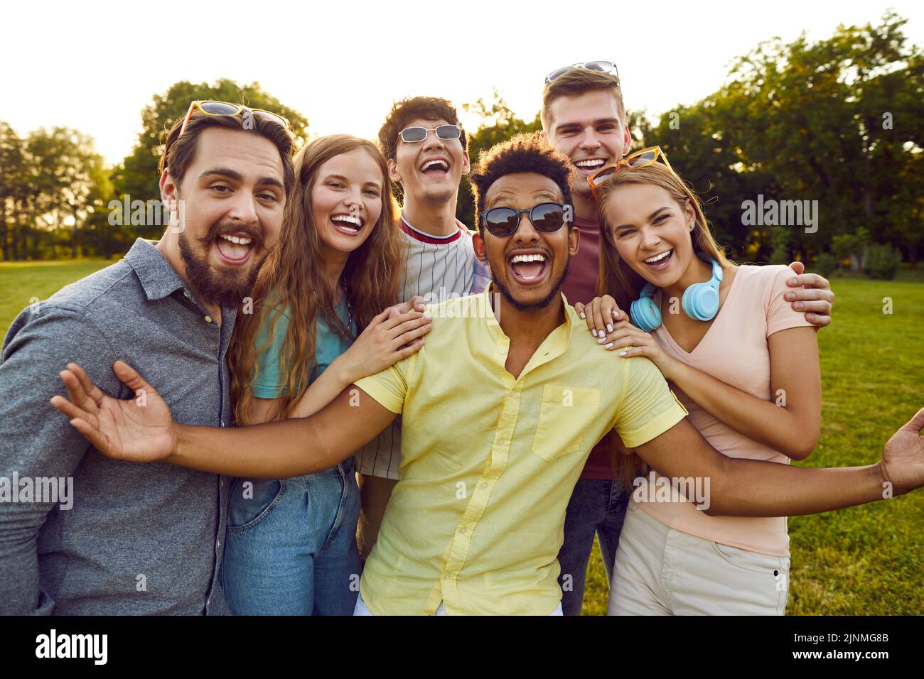 Group of happy young diverse people meet up in summer park and have fun all together Stock Photo ...