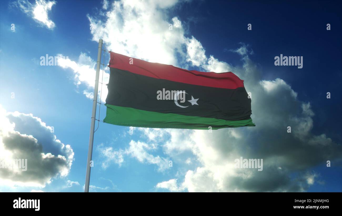 Flag of Libya waving at wind against beautiful blue sky. 3d ...
