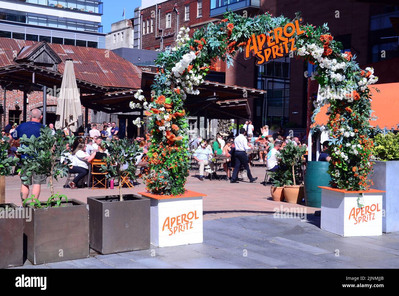 People enjoy a drink at an open air bar in Spinningfields district ...