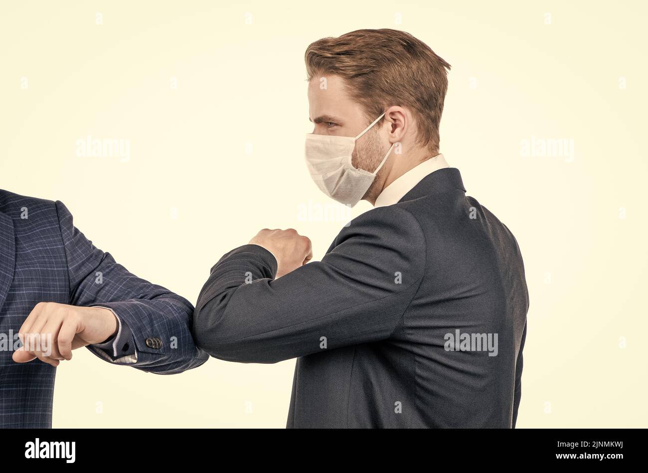 Elbow bump is the new handshake. Broker in face mask elbow bump with ...